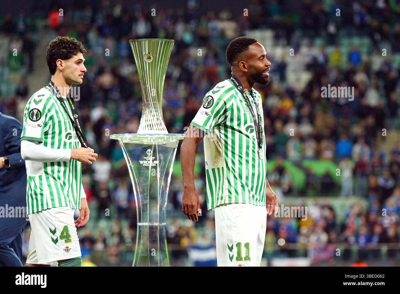 Real Betis' Johnny Cardoso and Cedric Bakambu walk past the trophy ...