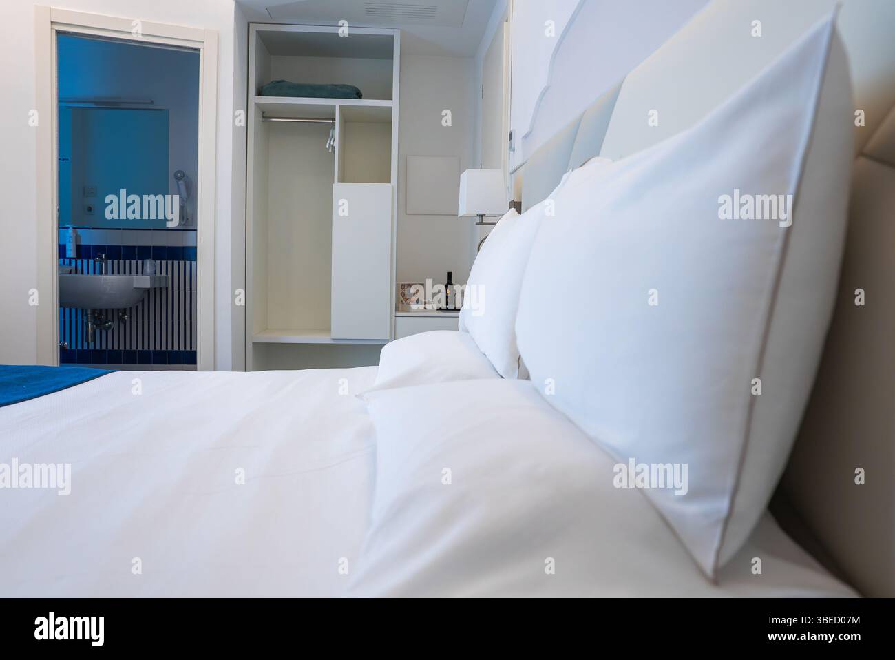 Modern Hotel Room with White Linens and Open Wardrobe in Amalfi Stock ...