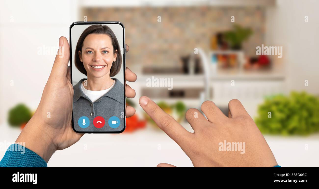 Engaging in a friendly video call from a cozy kitchen space Stock Photo ...