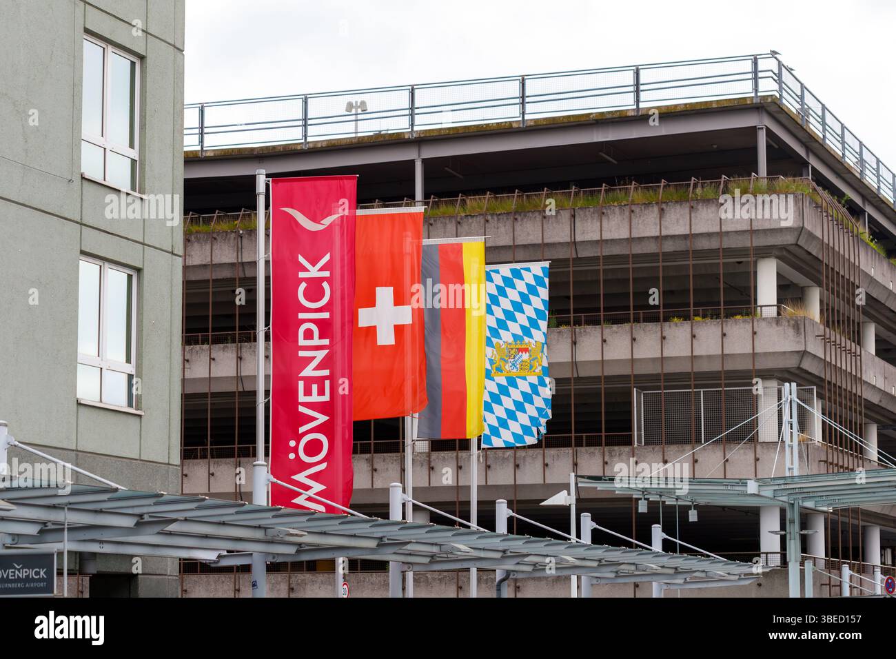 Nuremberg, Germany - 25th May 2025: Four flags stand in front of a ...