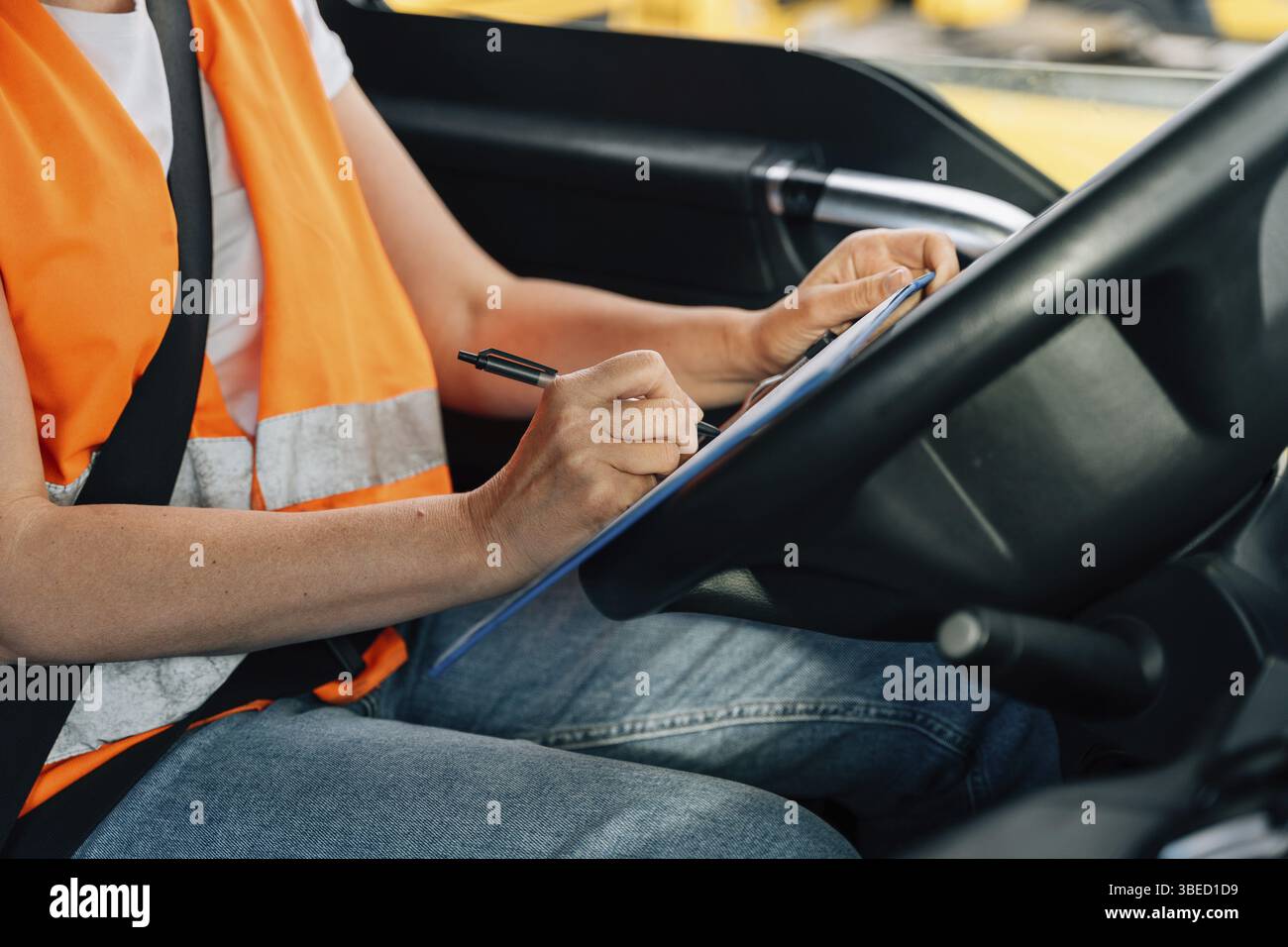Mature woman truck driver steering wheel inside lorry cabin. Happy ...