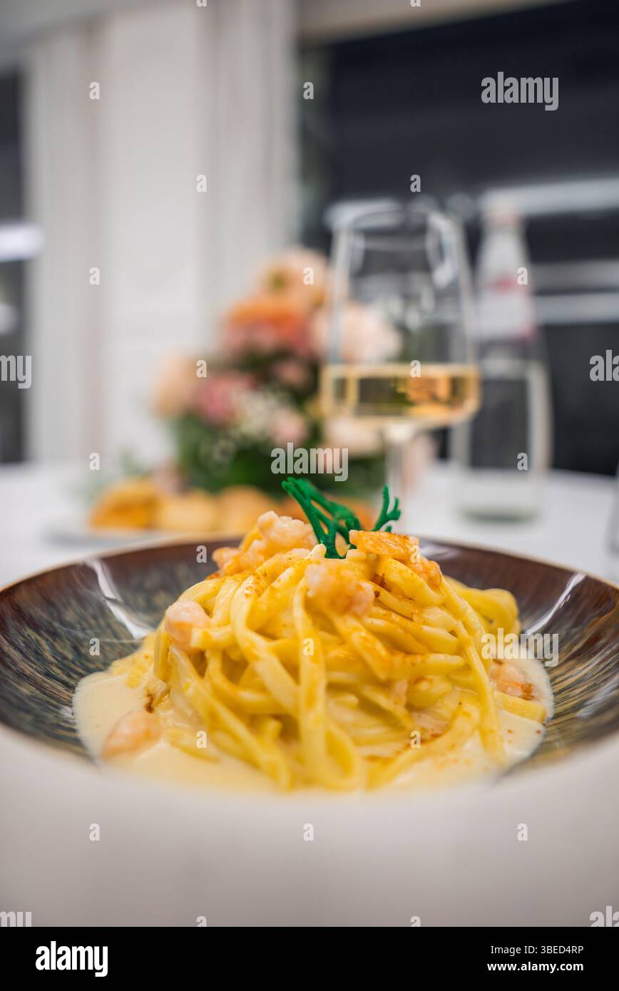 Creamy Pasta Dish with Herb Garnish in Elegant Dining Setting Stock ...