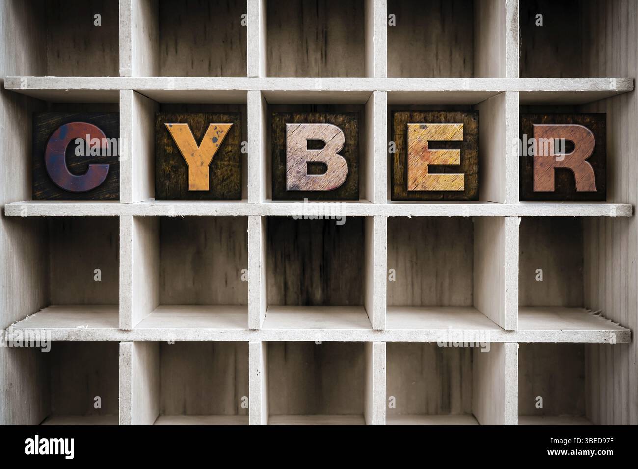 The word CYBER written in vintage ink stained wooden letterpress type ...