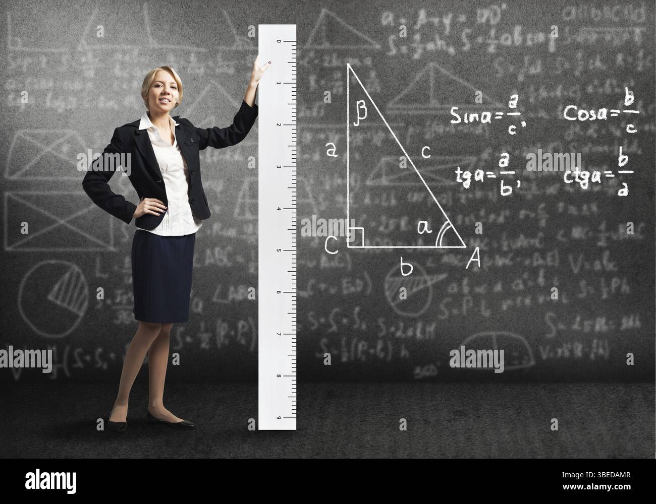 Young mathematics teacher holding big ruler on background chalkboard ...