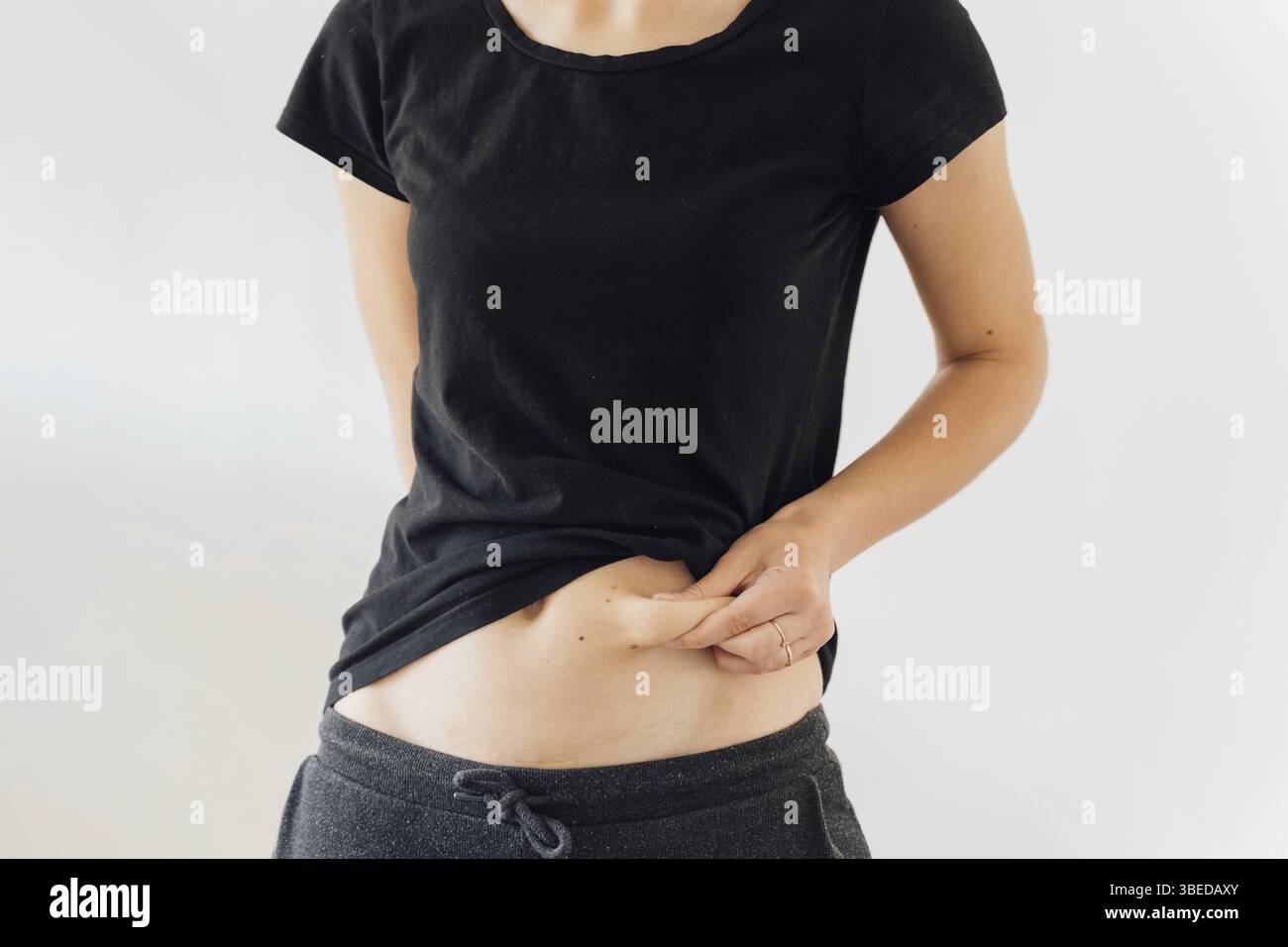 YOung woman holding her belly fat. Weight access, diabetic tummy ...