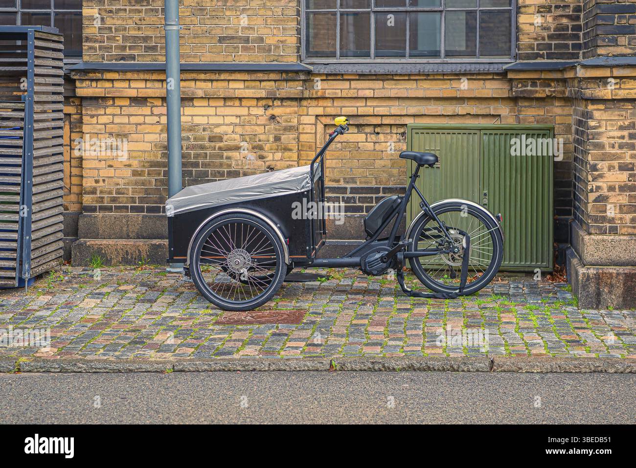 A tricycle cargo family bike with box for the transport of children ...