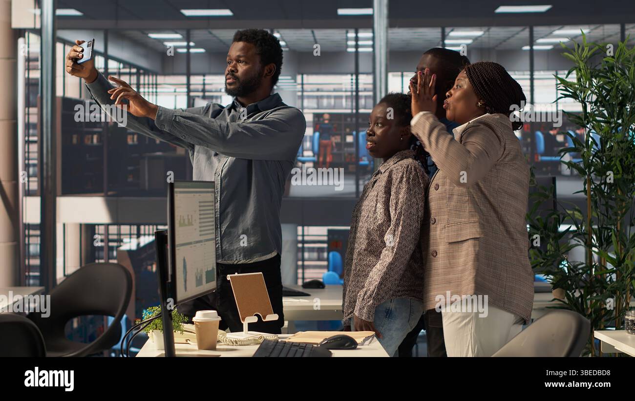 United african american employees taking photos at the corporate office ...