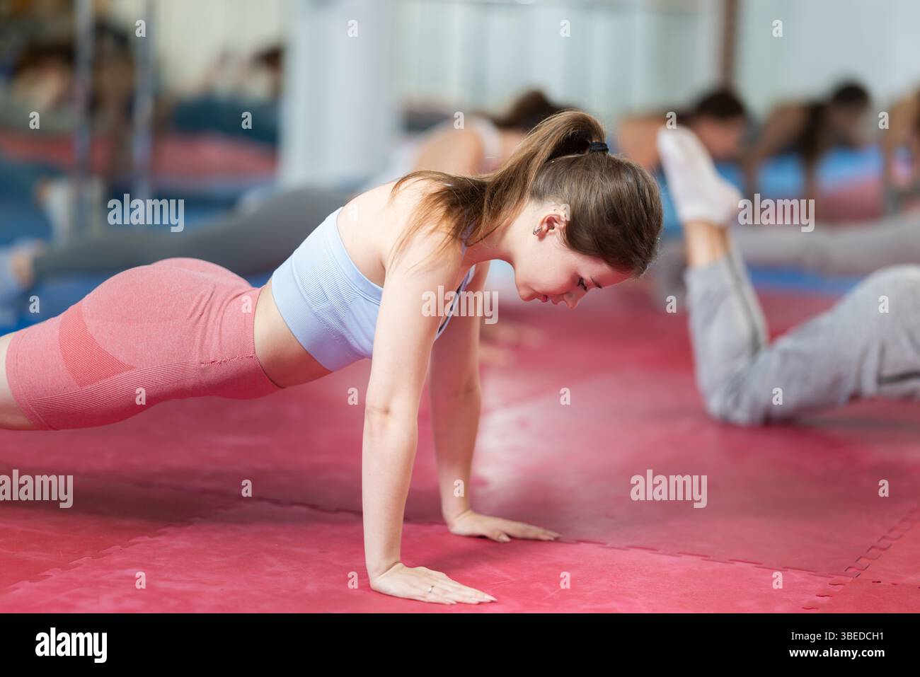 Women standing in plank during training Stock Photo - Alamy