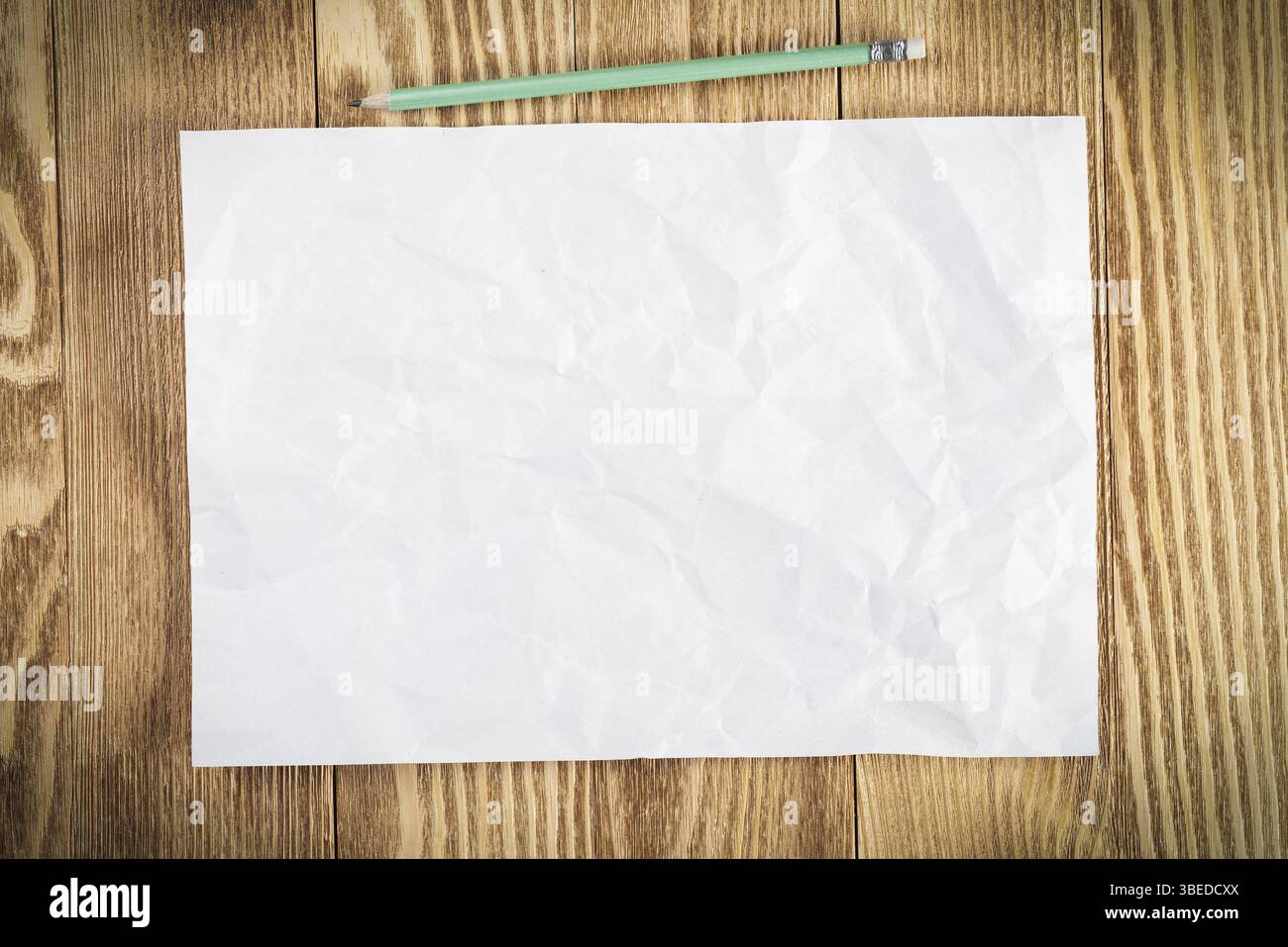 Sheet of paper lying on wooden table. Blank white a4 format paper with ...