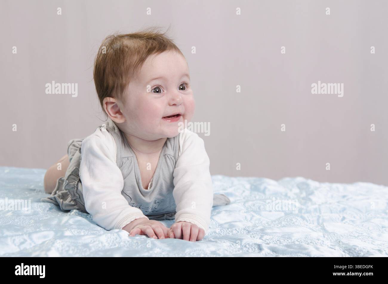 Six-month beautiful charming girl on the couch Stock Photo - Alamy