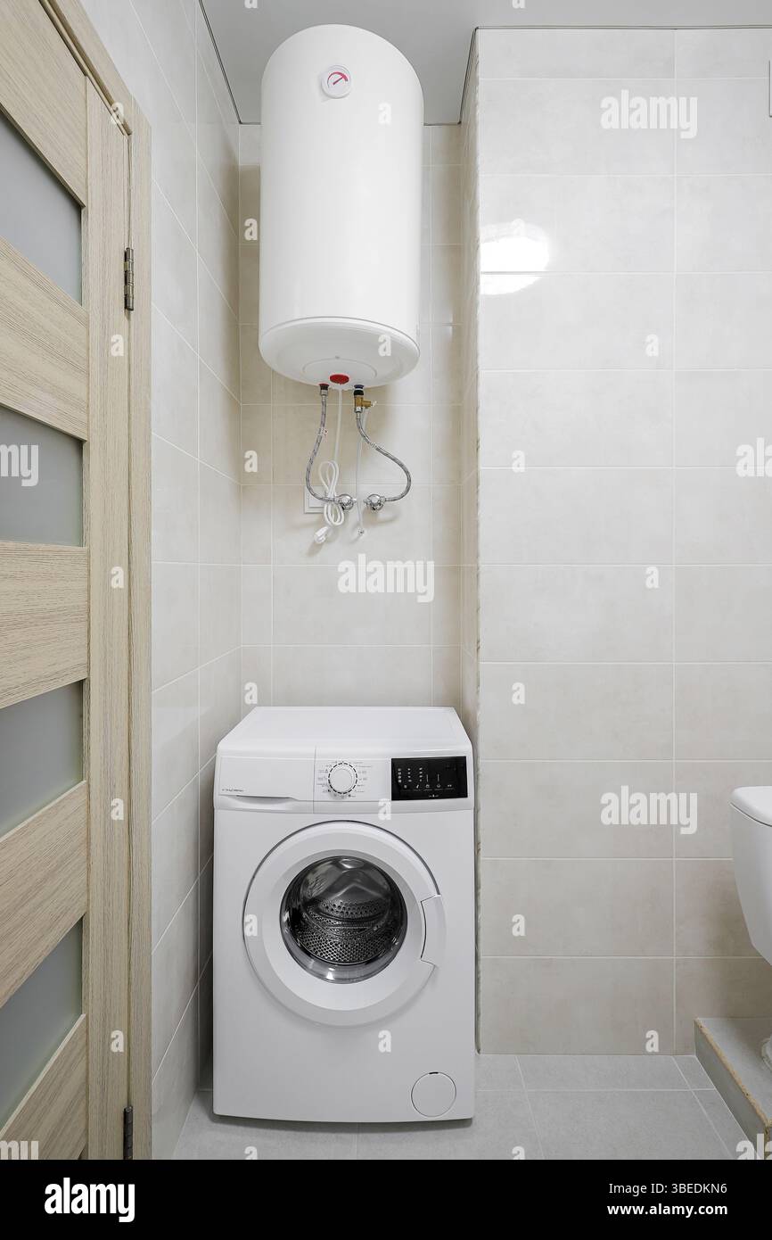 Washing machine and electric water heater in the bathroom Stock Photo ...
