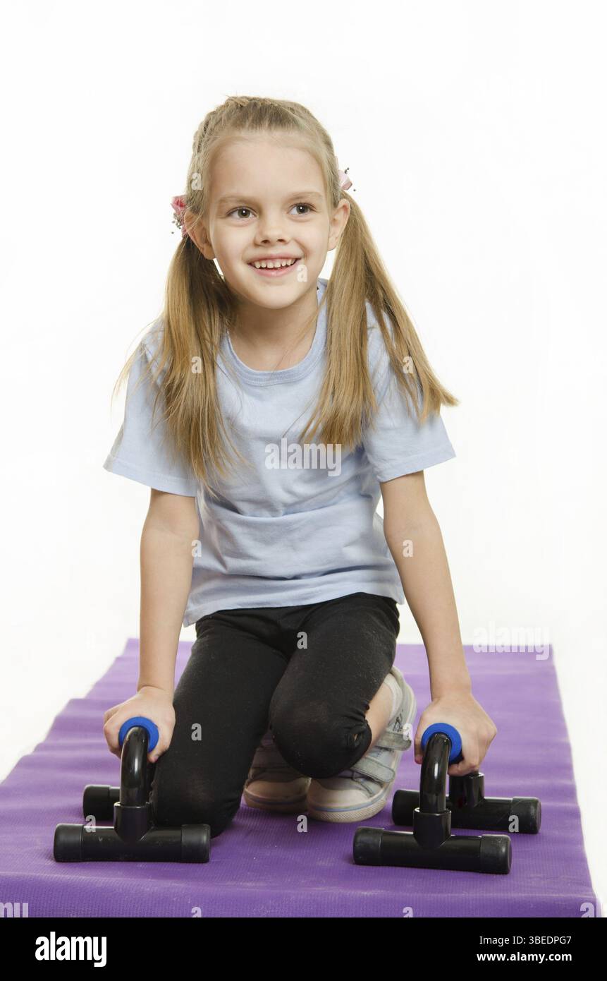 Six year old girl Europeans engaged in physical exercises Stock Photo ...