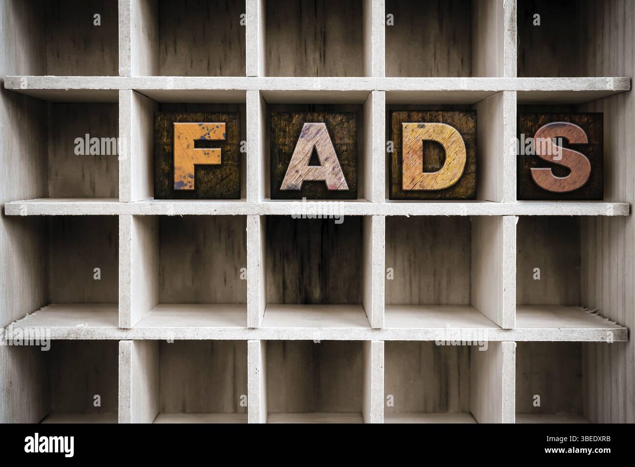 The word FADS written in vintage ink stained wooden letterpress type in ...