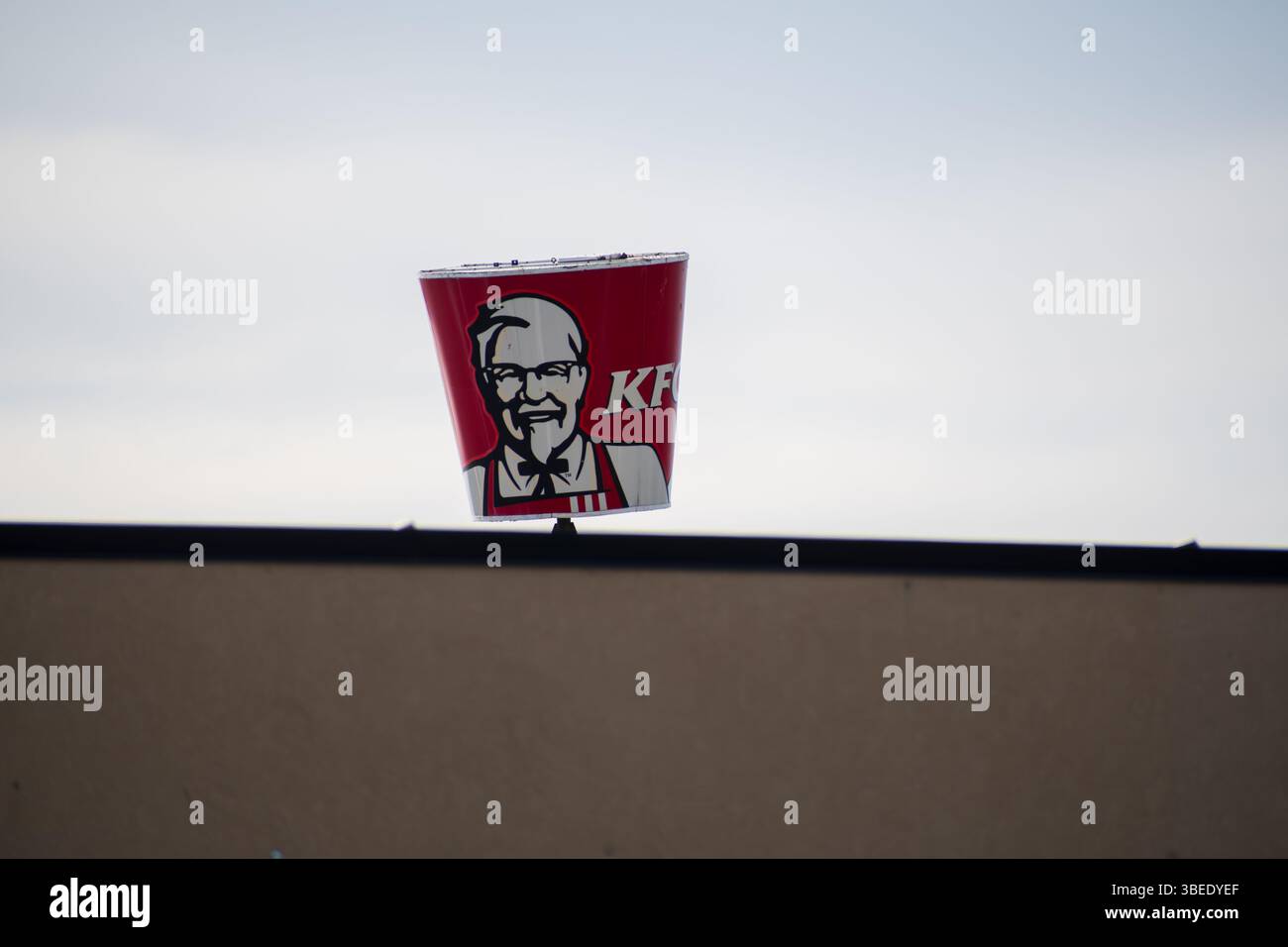 Spanish Fork, UT—May 28, 2025: A bucket of chicken sign sits atop a KFC ...