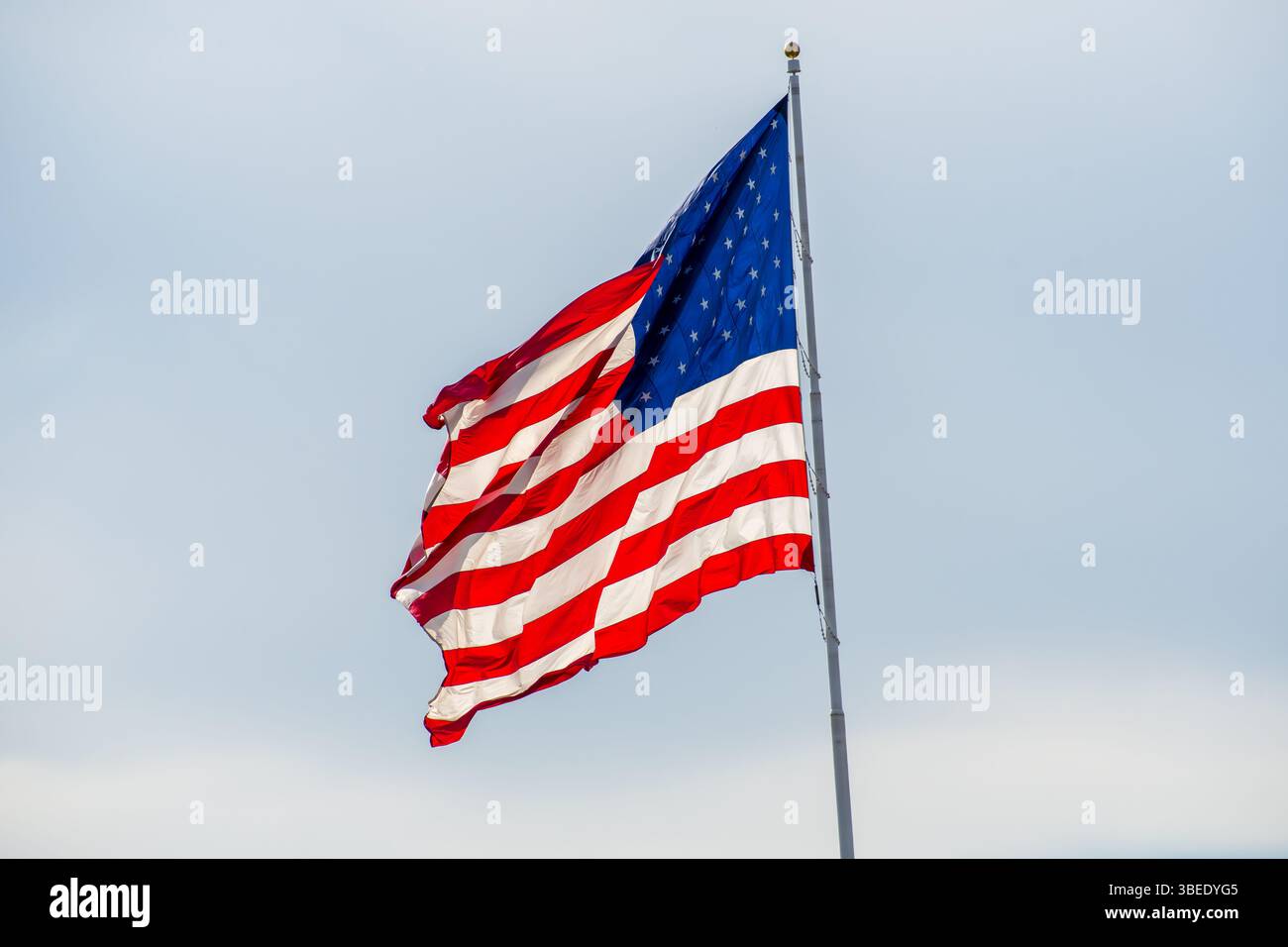 American Fork, UT—May 28, 2025: An American flag waves along Interstate ...