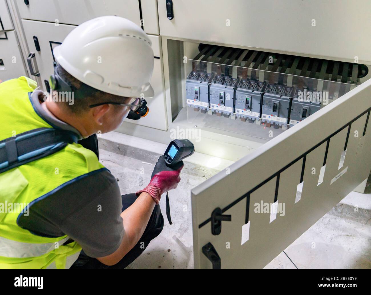 The electrician engineer uses a thermal imaging camera to examine the ...