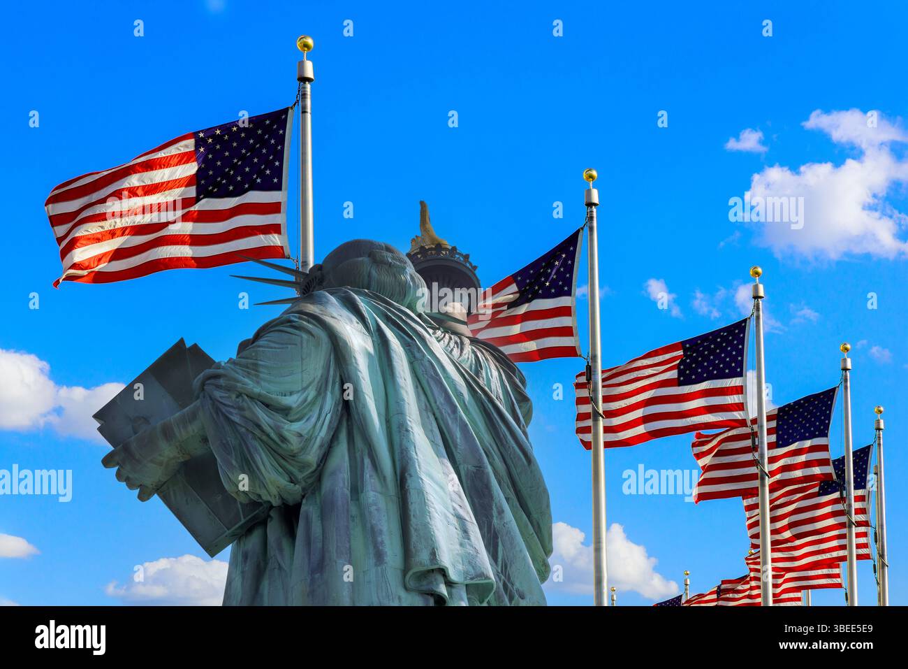 Statue of Liberty stands proudly with multiple American flags ...