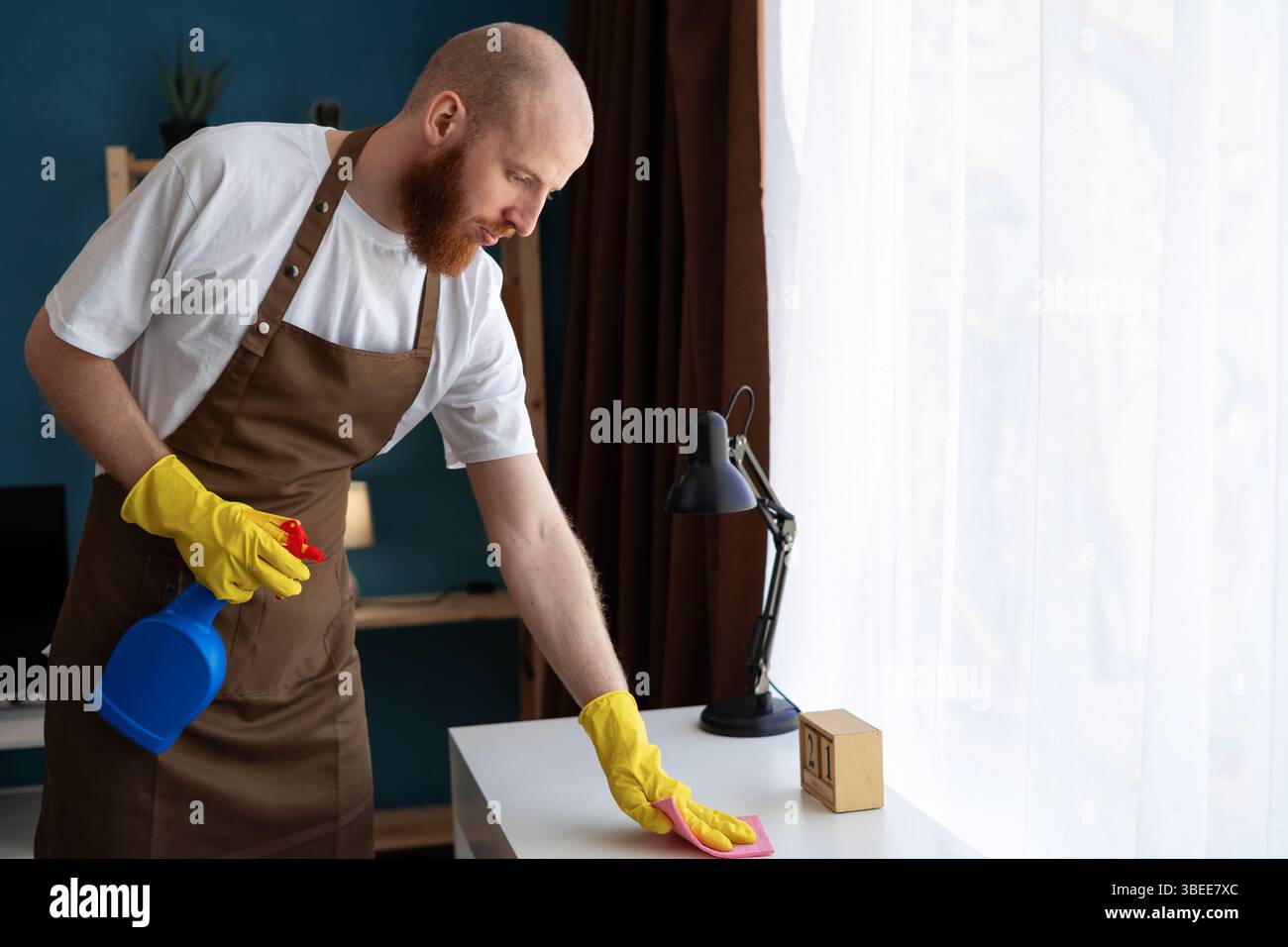 cleaning service concept. Bearded man with bottle for hygiene wiping ...