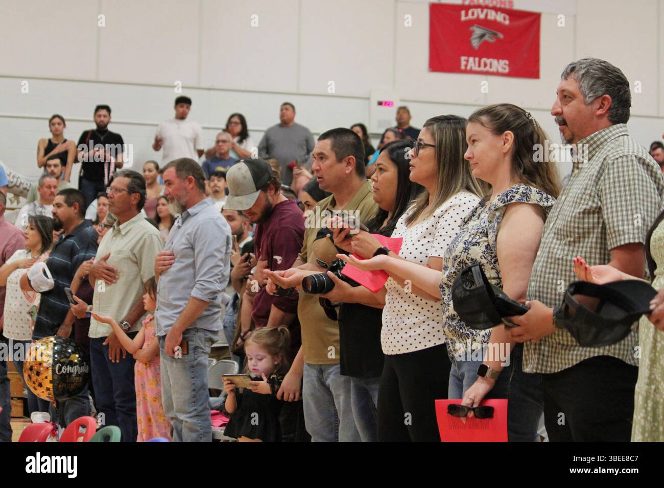 Family and friends recite the New Mexico state flag pledge ahead of a ...