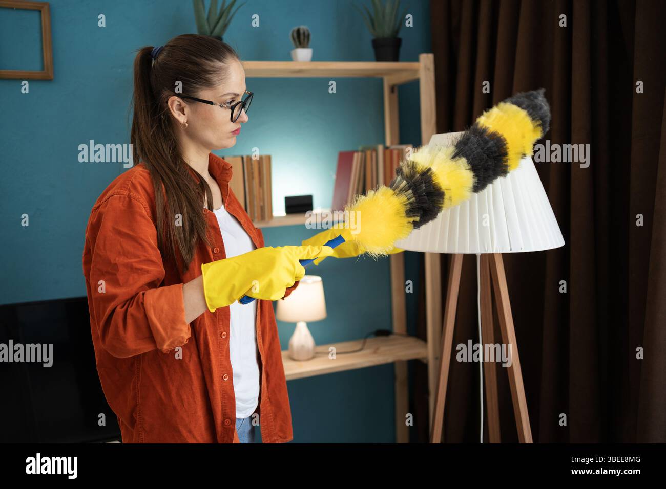 Woman dusting lamp feather hi-res stock photography and images - Alamy