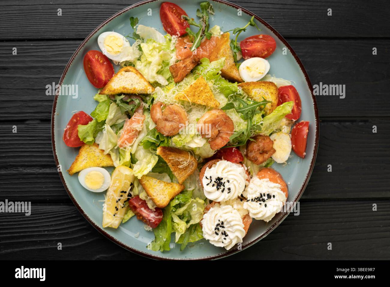 Seafood Caesar salad with shrimp, cherry tomatoes, sushi rolls with ...