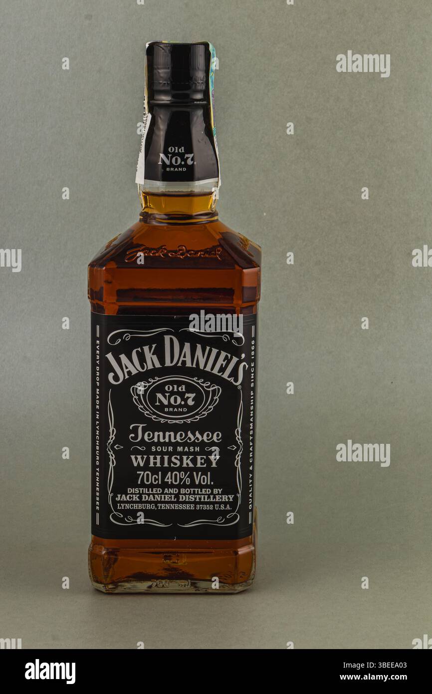 A well-known whiskey bottle stands upright, displaying its distinctive ...