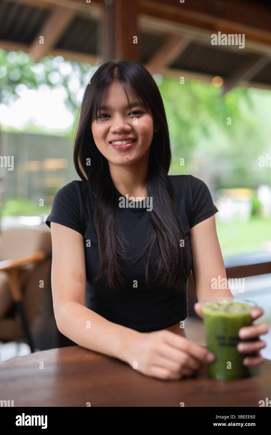 Young beautiful Asian student woman in cafe Stock Photo - Alamy