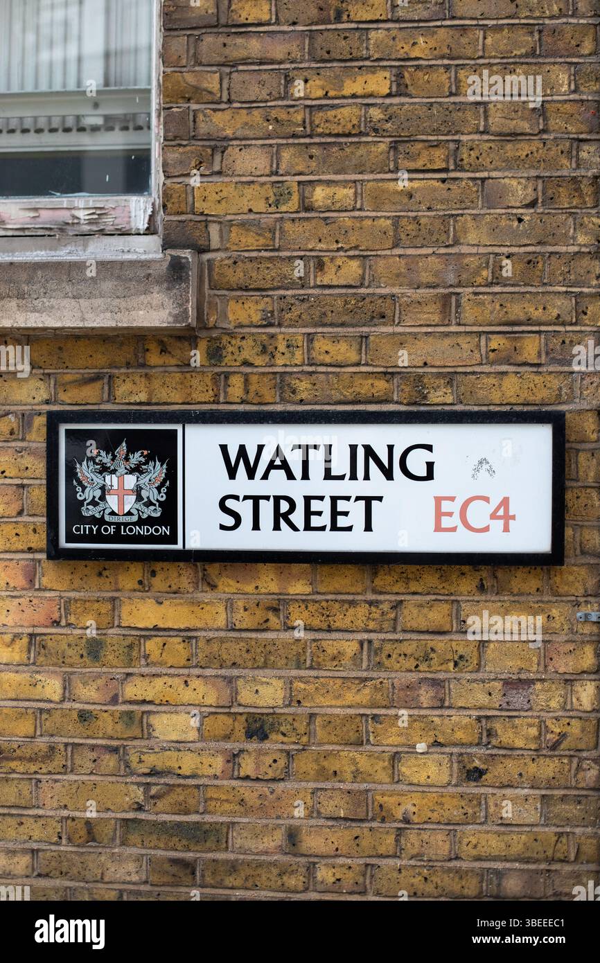 Street sign for Watling Street in London on a brick wall. City emblem ...