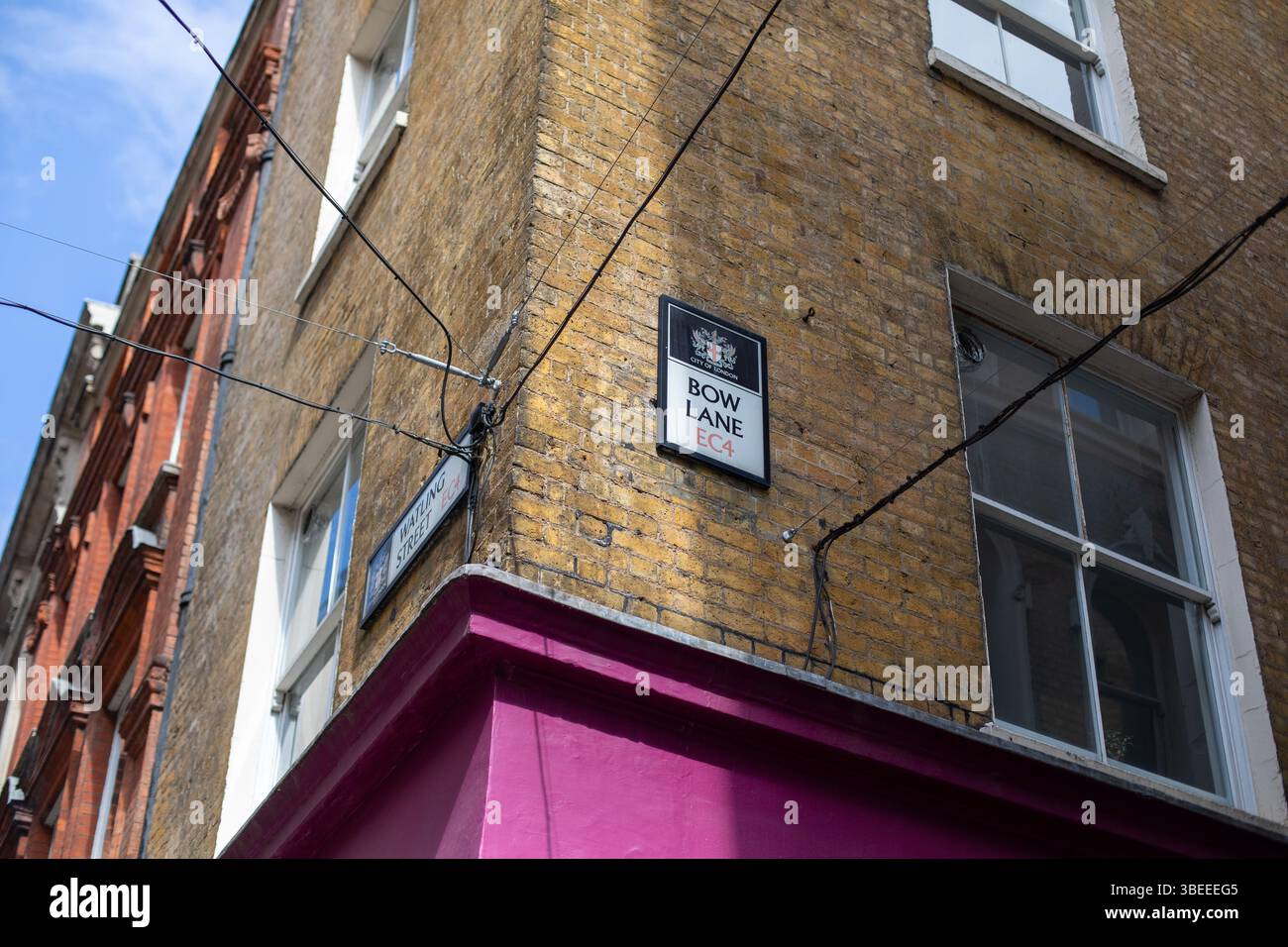 Street signs of Bow Lane and Watling Street on a brick building in ...