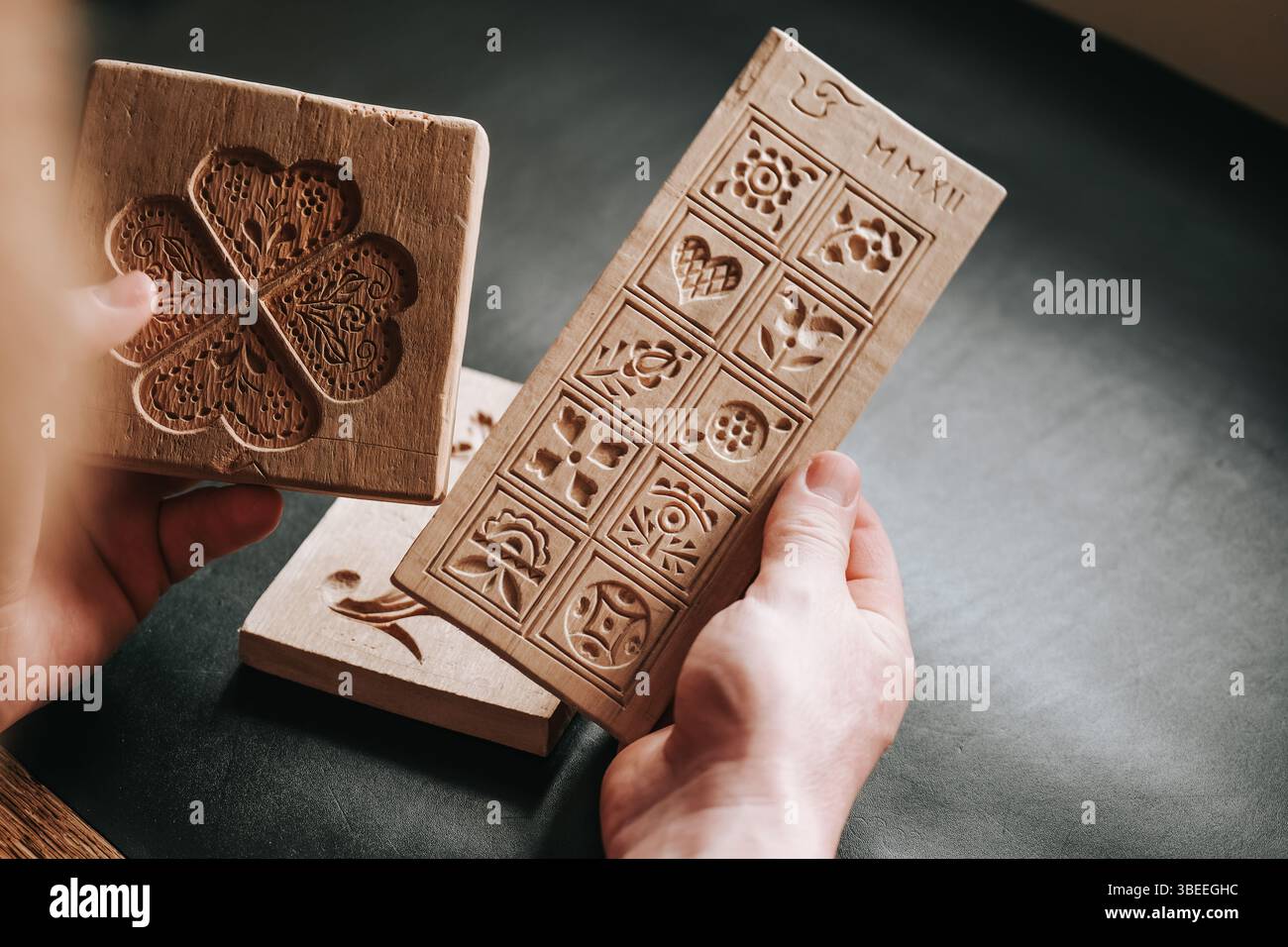 Wooden stamps for cookies and gingerbread in the hands of a man. baking ...