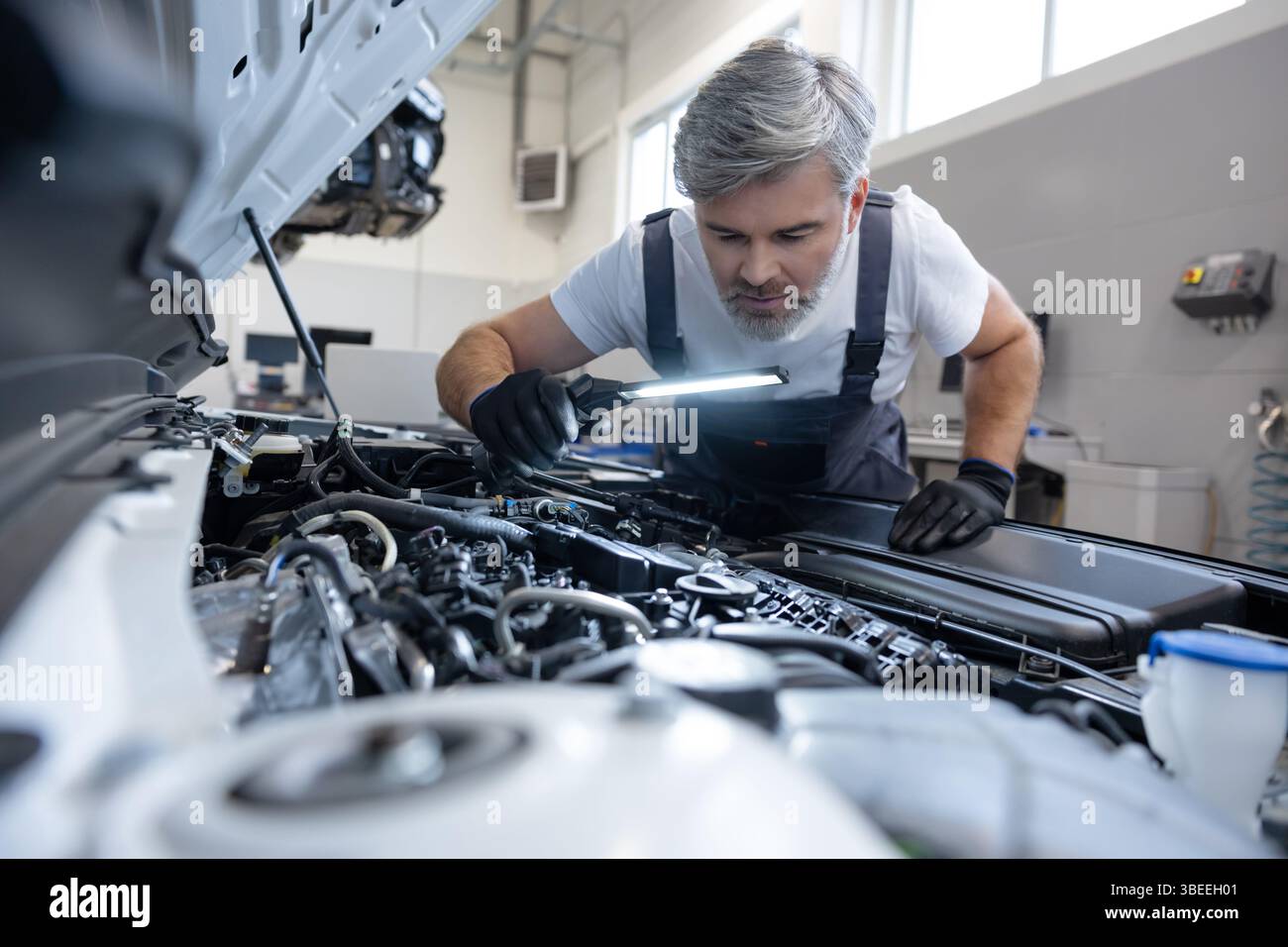 Mechanic examining engine components hi-res stock photography and ...