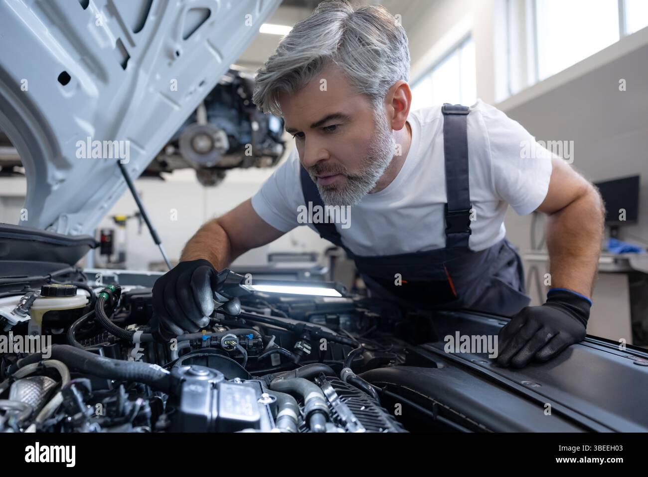 Mechanic examining engine components hi-res stock photography and ...