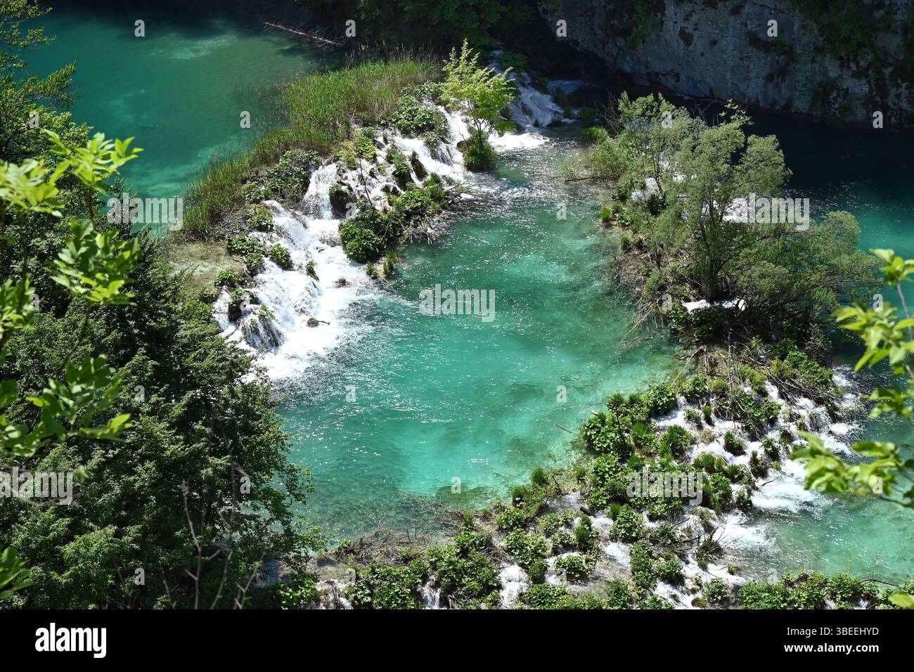 Waterfalls and small lakes surrounded by lush greenery and turquoise ...