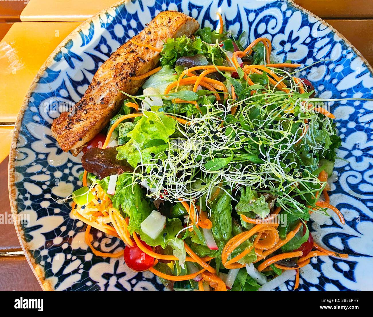 Fresh vegetable salad with a piece of fried salmon Stock Photo - Alamy