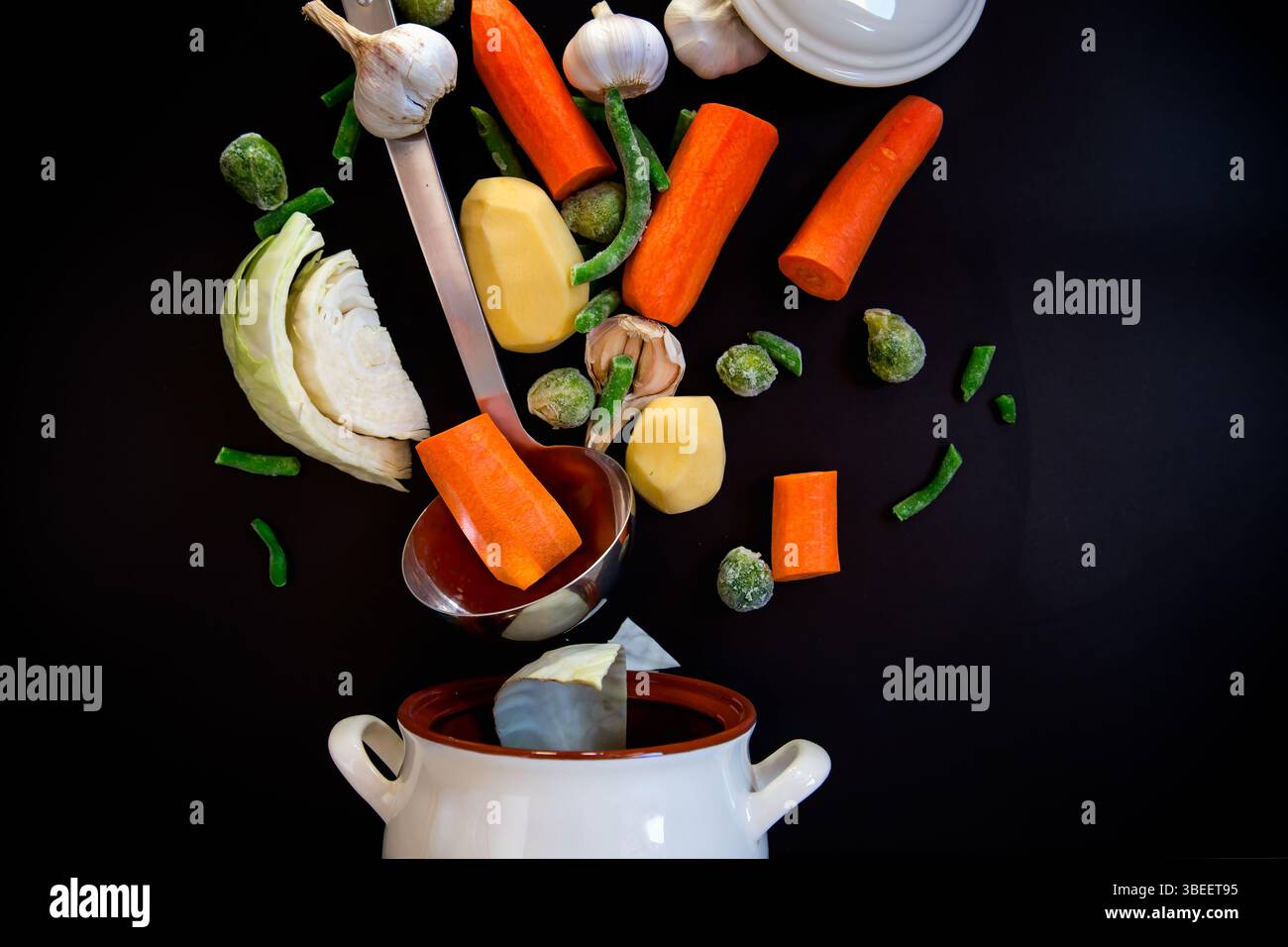 Vegetables in motion before cooking in soup Stock Photo - Alamy