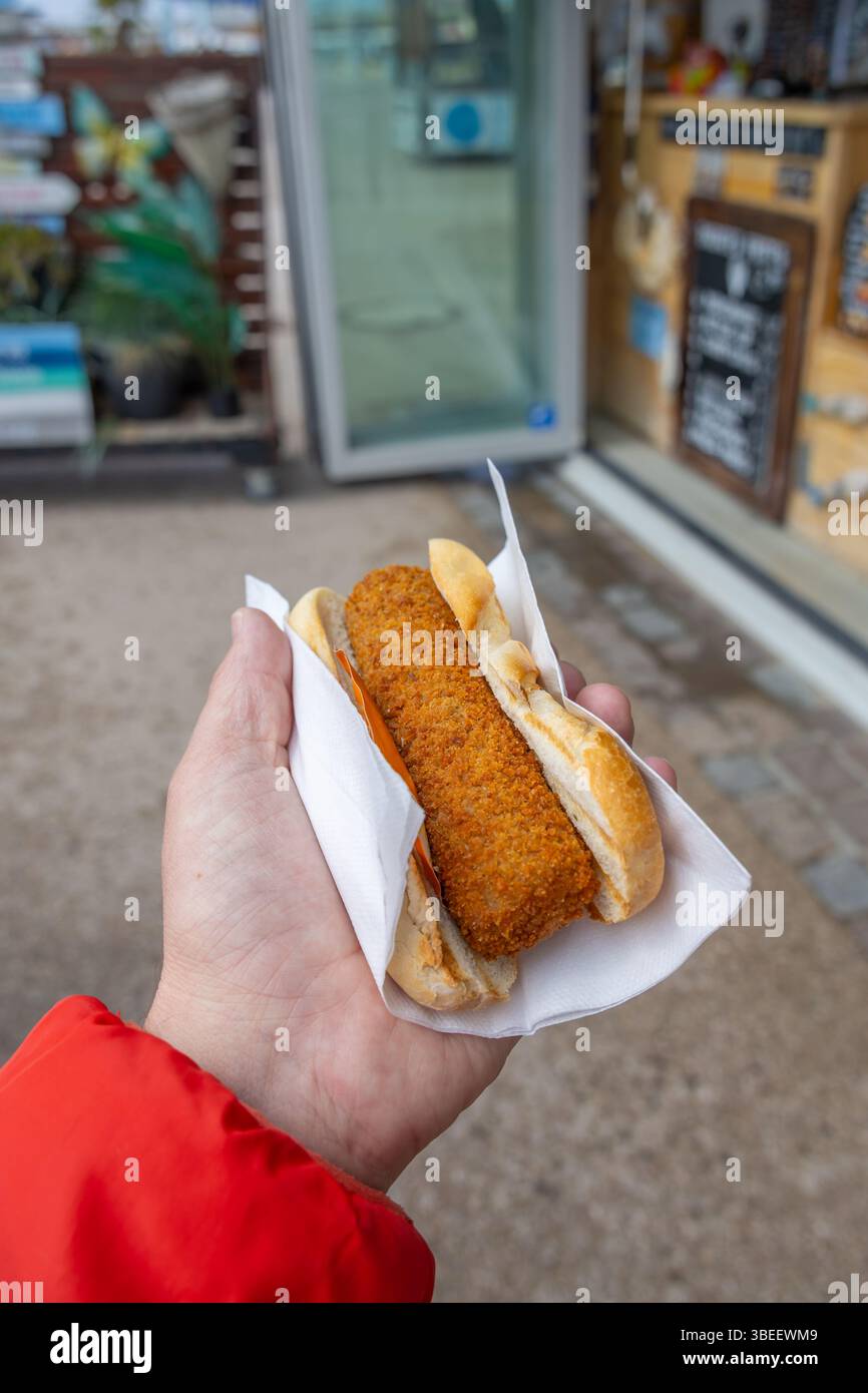 Dutch kroket in a bread roll fast food at a fast food cafe Stock Photo ...