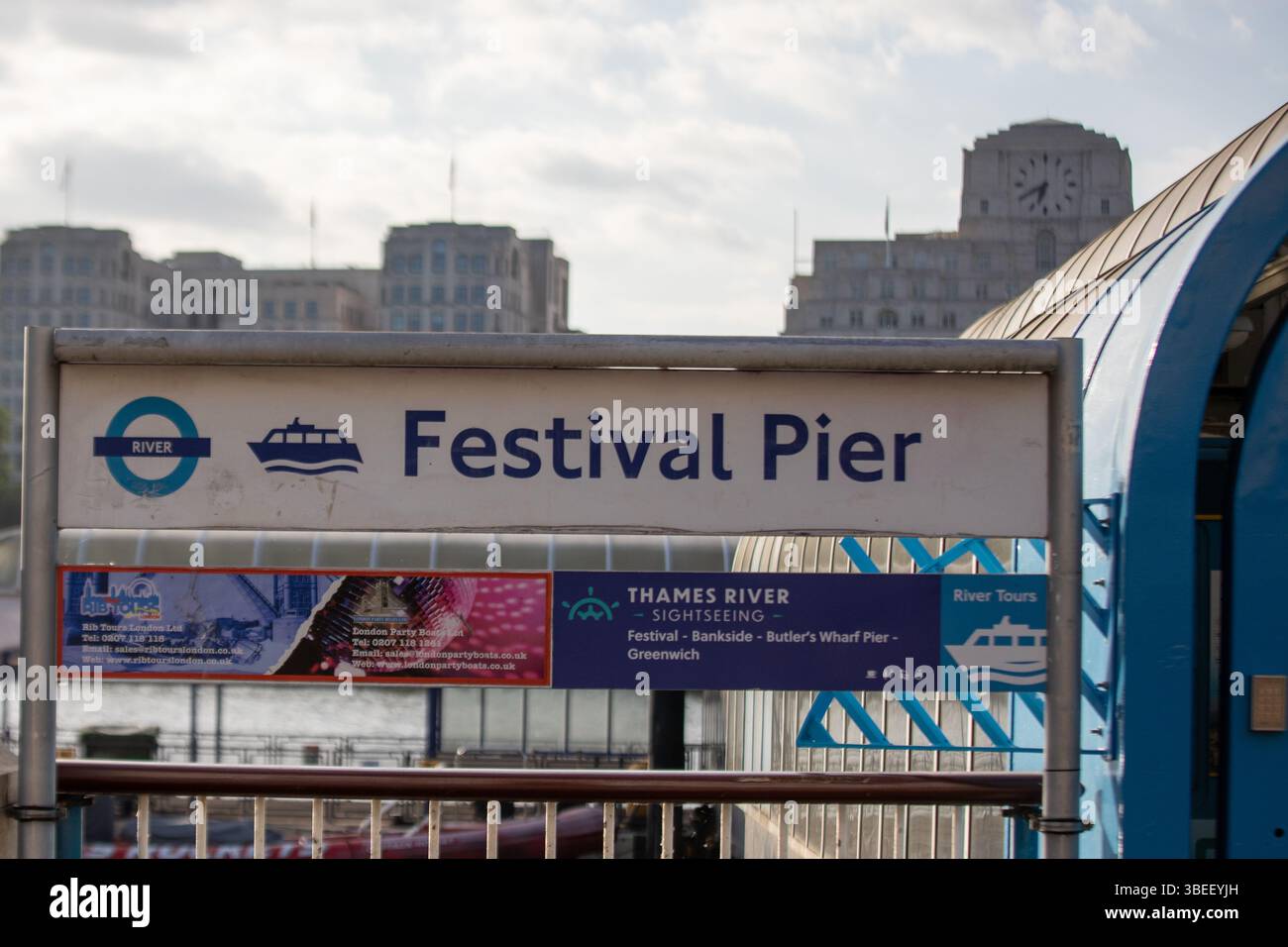 Close-up of the Festival Pier sign in London with a backdrop of city ...