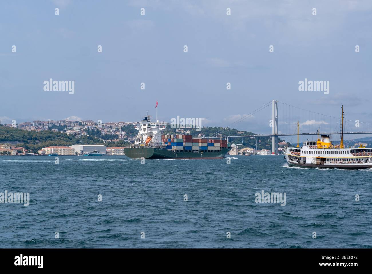 Bosphorus strait bustling with cargo ships and ferries traveling under ...