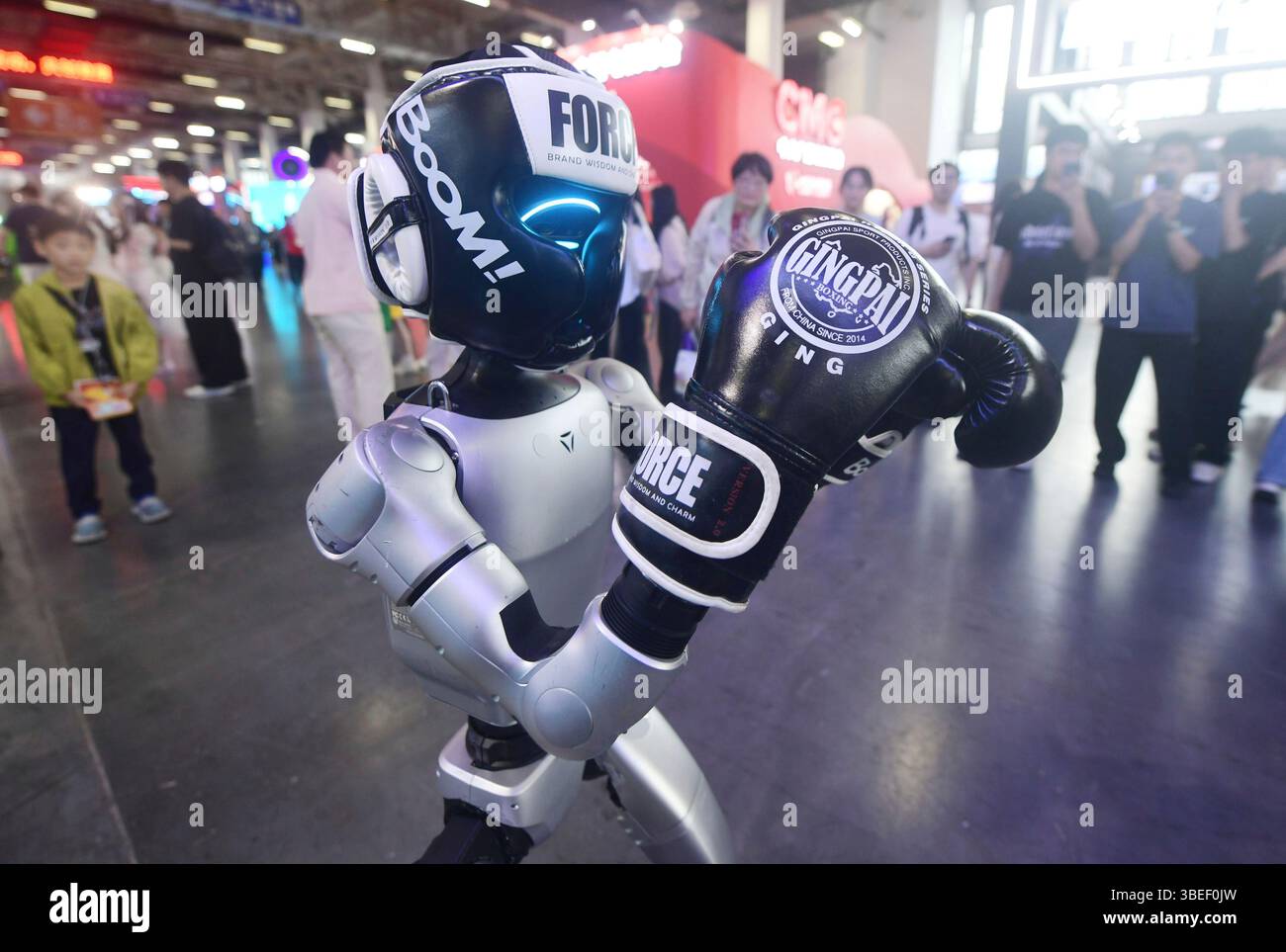 A boxing humanoid developed based on Unitree's G1 robot interacts with visitors during the China ...