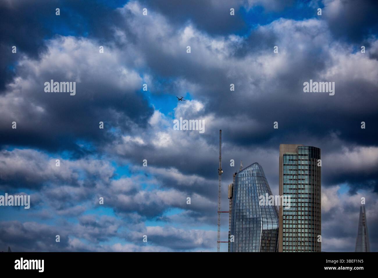 A dramatic London skyline with modern skyscrapers under cloudy skies ...