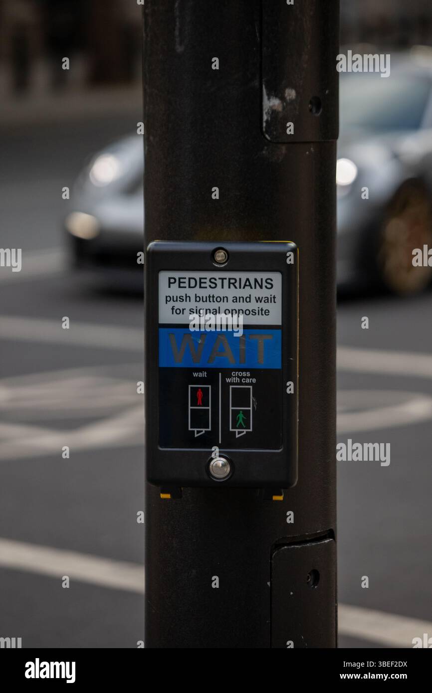 Close-up of a pedestrian crossing button on a street in London. The ...