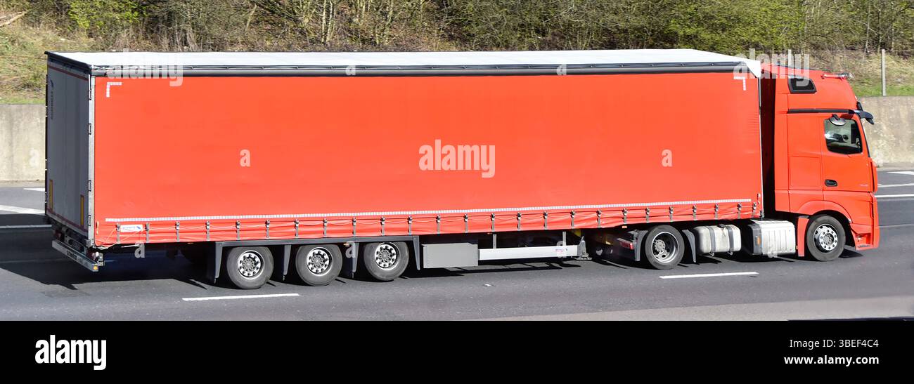 Side view clean unmarked red colours long hgv lorry truck & soft sided ...