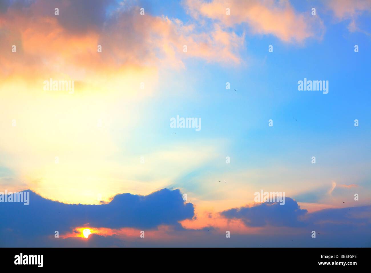 Sky is painted with breathtaking colors as the sun sets behind a ...
