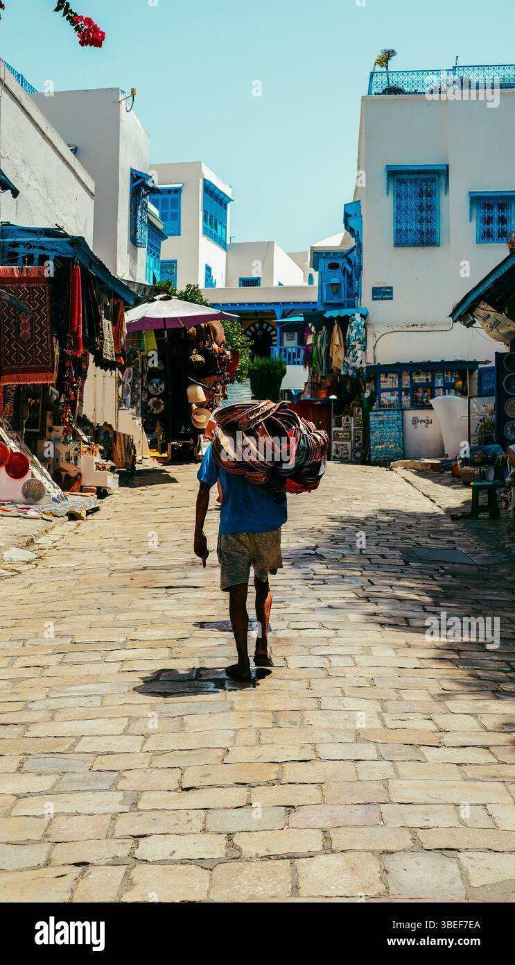 Local vendor walking with his leather product in Tunisia Stock Photo ...