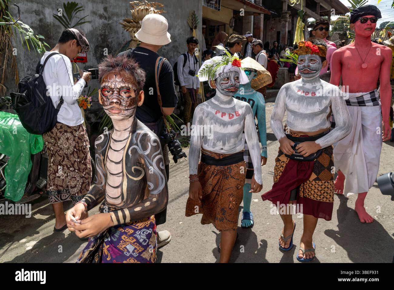 A group of children with their bodies painted is seen gathered before ...
