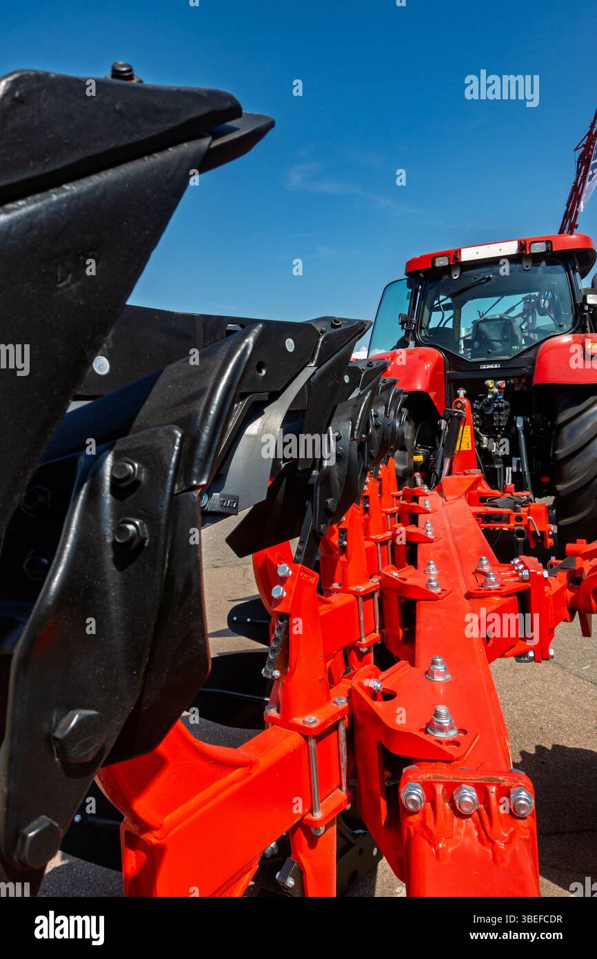 Close Up Shot of a Modern Red Tractor and its Black Agricultural ...