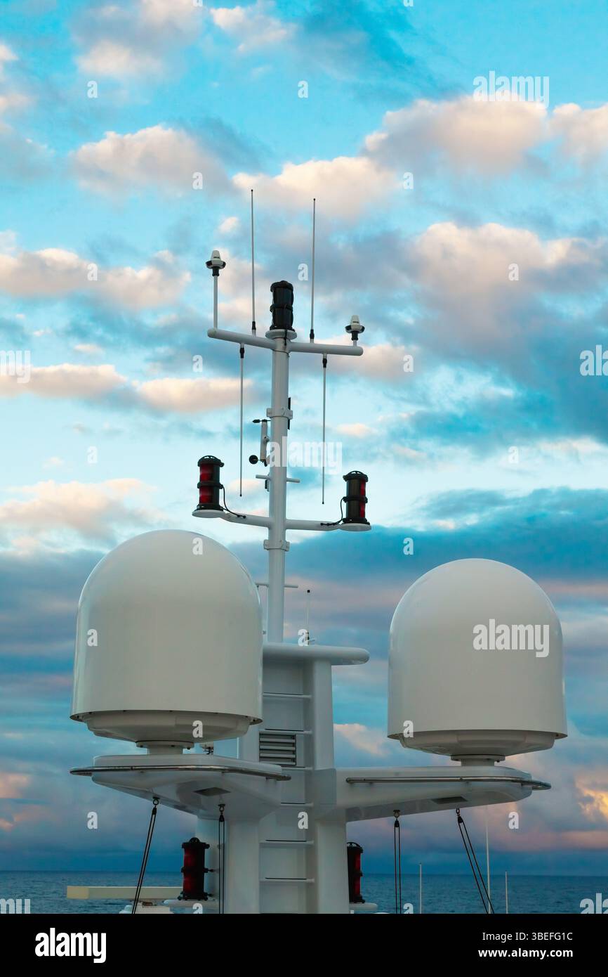 The mast of a large yacht with navigation equipment bottom view. Radar ...