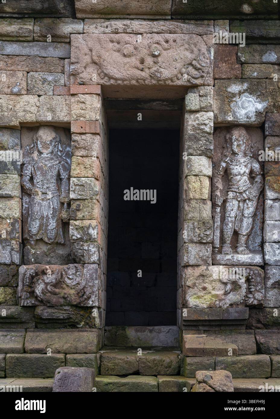 Vertical view of ancient hindu Gedong Songo III temple door with ...