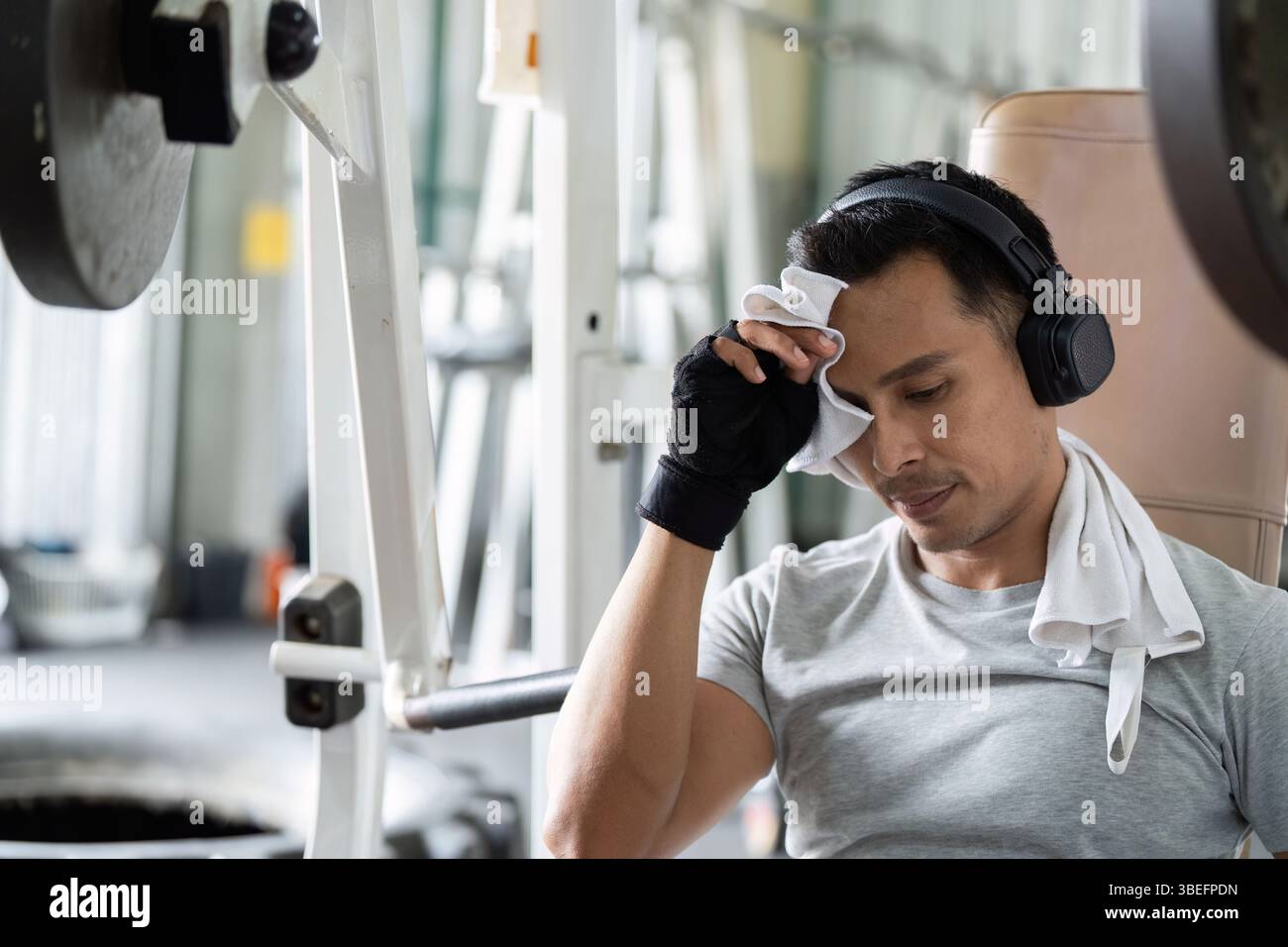 Fitness and Resilience. Sweaty man taking a break during workout in gym ...