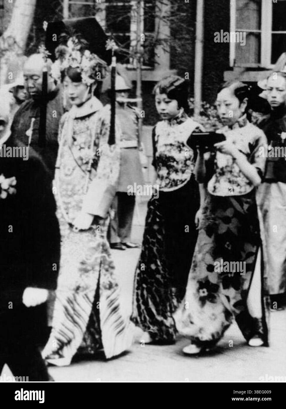 A photograph from June 7, 1934, shows Wanrong, in glasses ...